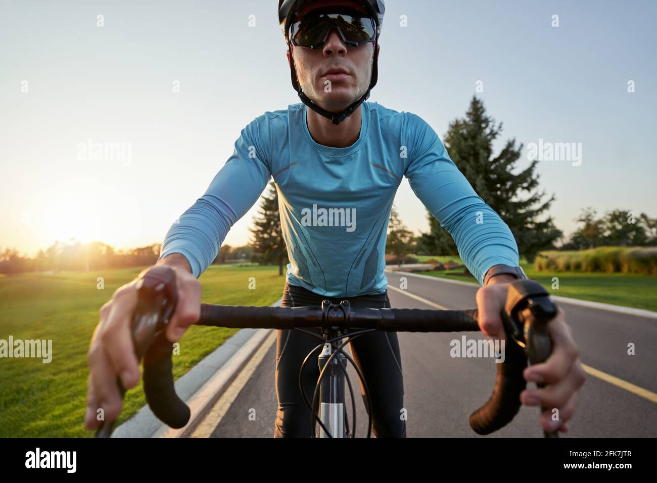 Focused professional young male racer in sportswear and protective ...