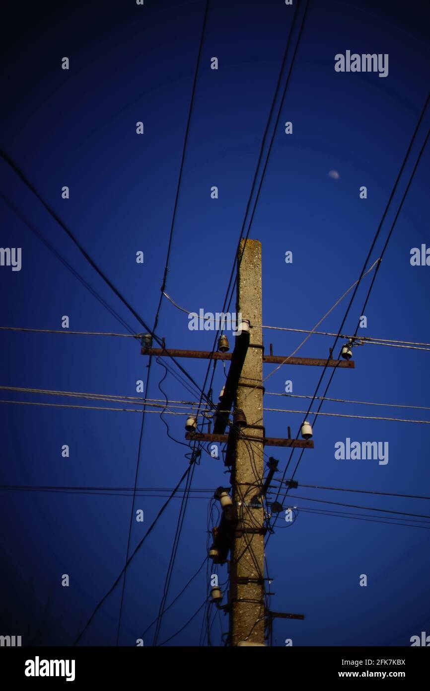 Electric pole in the deep blue sunset sky Stock Photo - Alamy