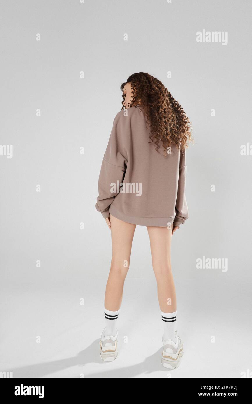 A young model woman with perfect long legs and slim body wearing a grey ...