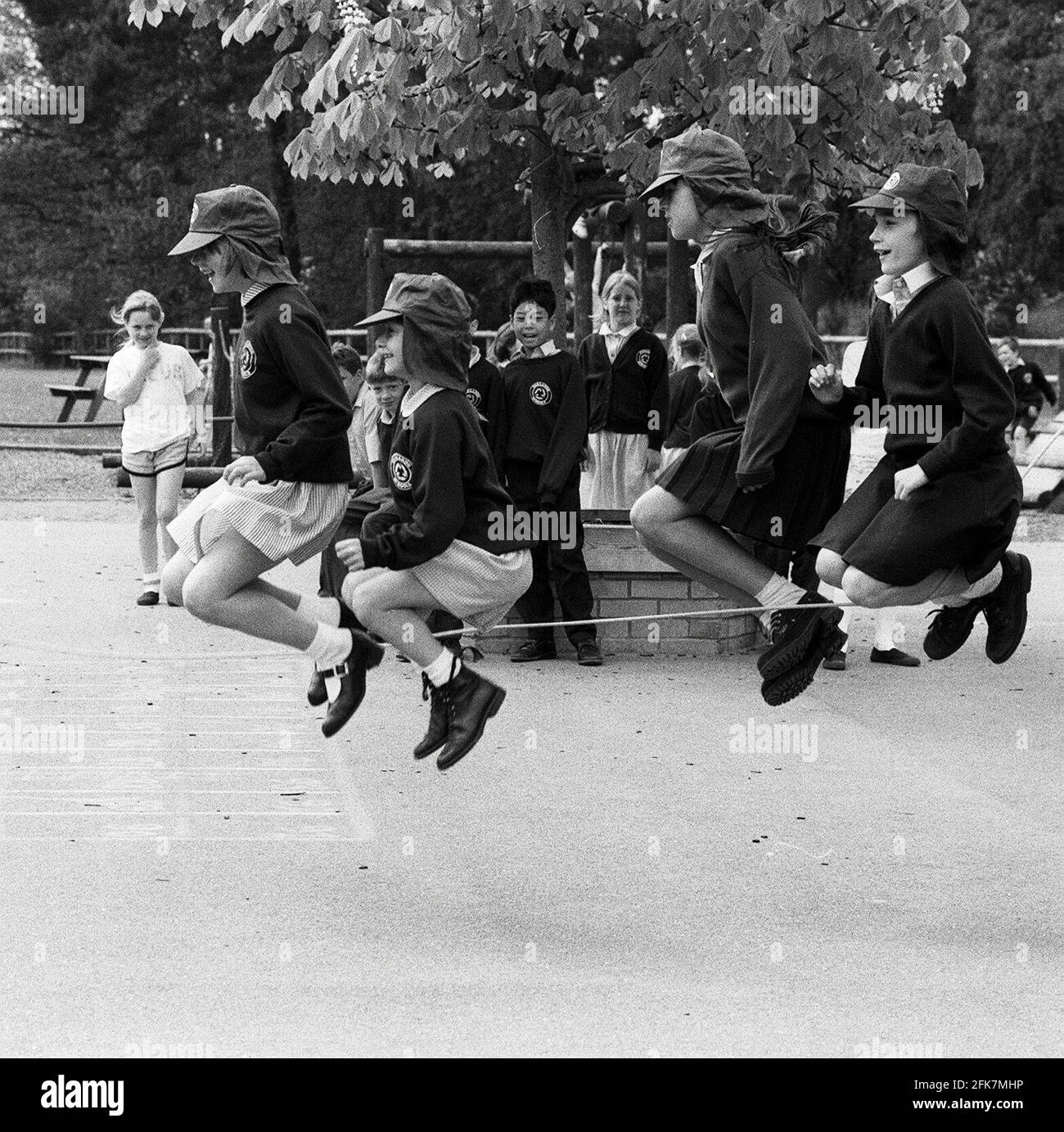 Some young lively schoolgirls go wild in the playground at break ...