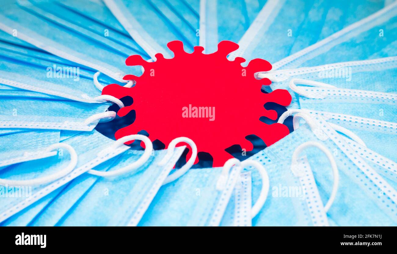 Virus among blue medical masks Stock Photo - Alamy