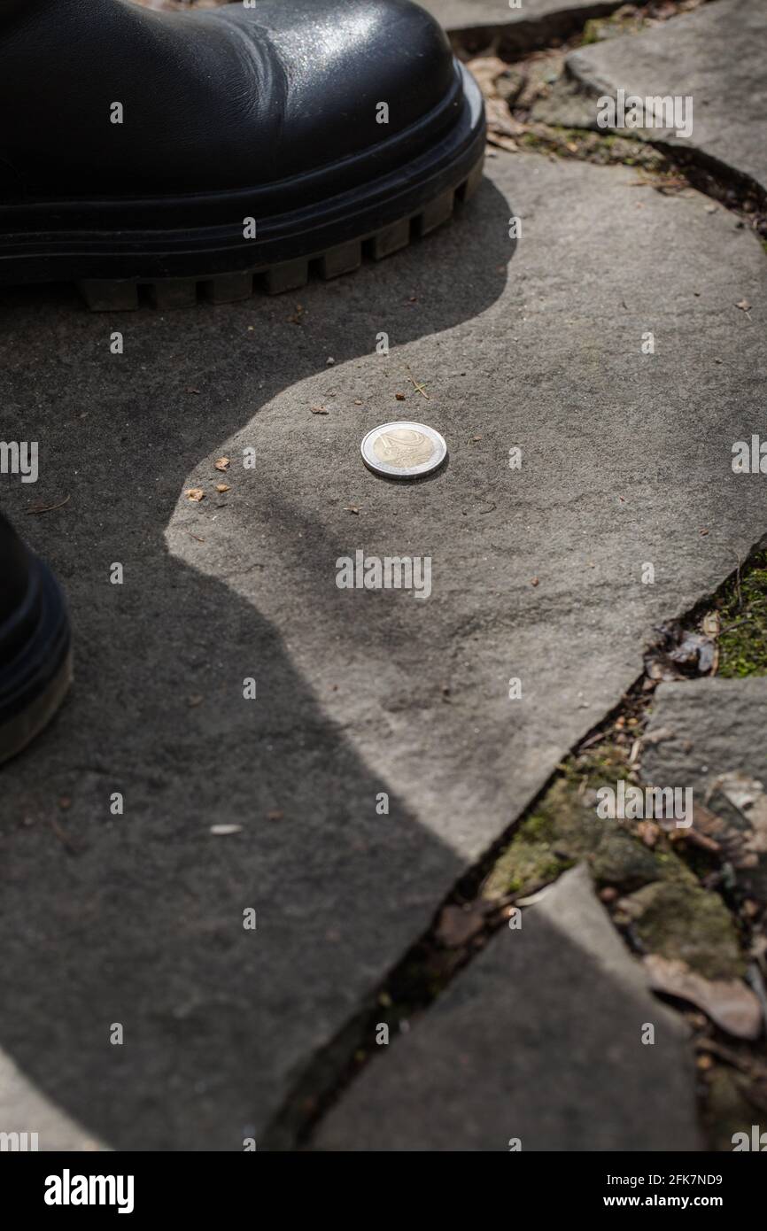 Lost and found money. Close-up of two euros coin on the ground Stock ...