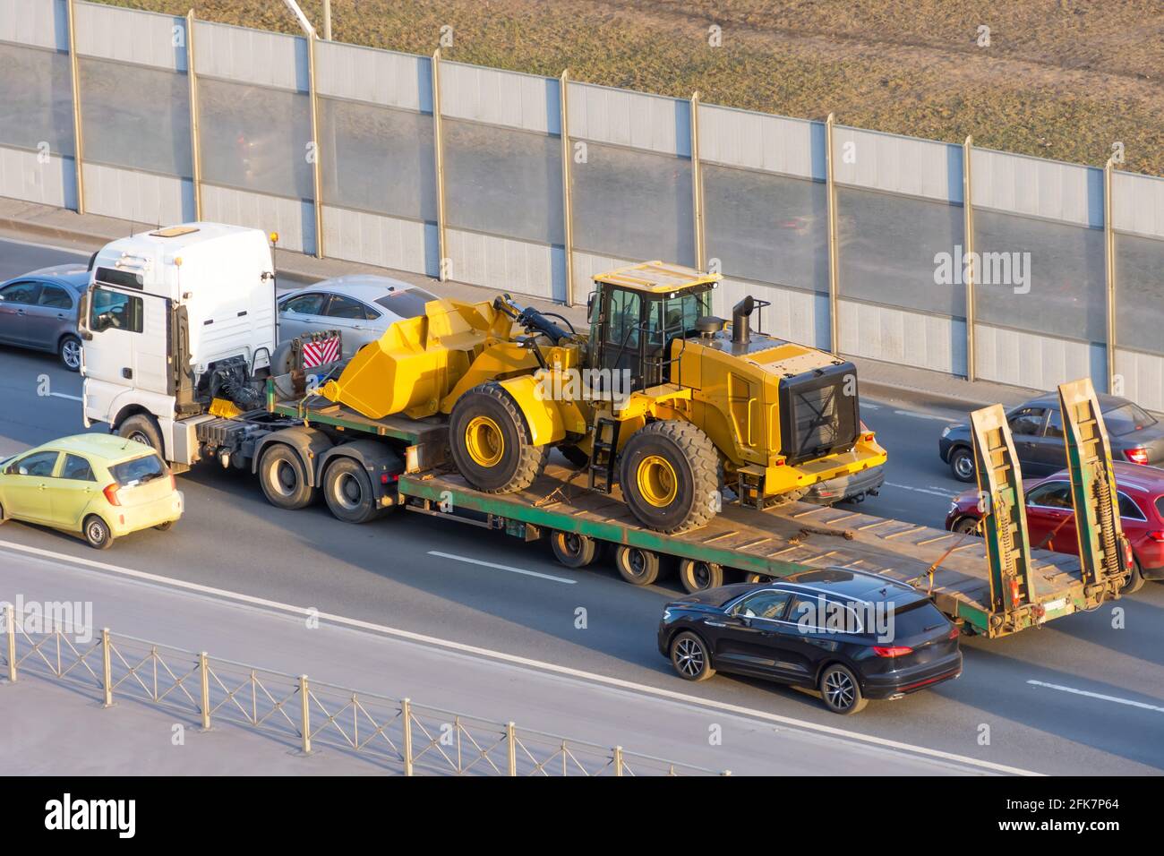 Truck with a long trailer platform for transporting heavy machinery ...