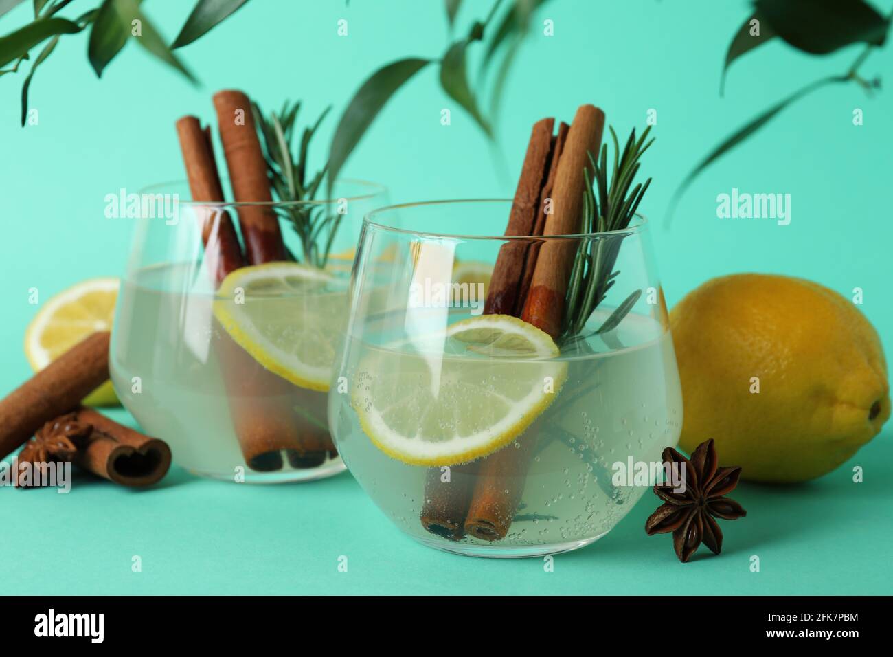 Glasses of lemonade with cinnamon and rosemary on mint background Stock ...