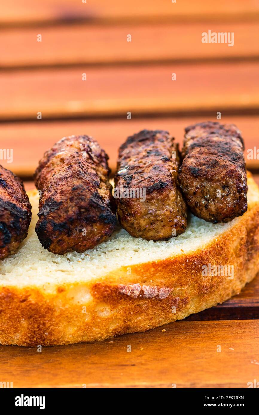 Meat rolls called mici or mititei on a slice of bread isolated Stock ...