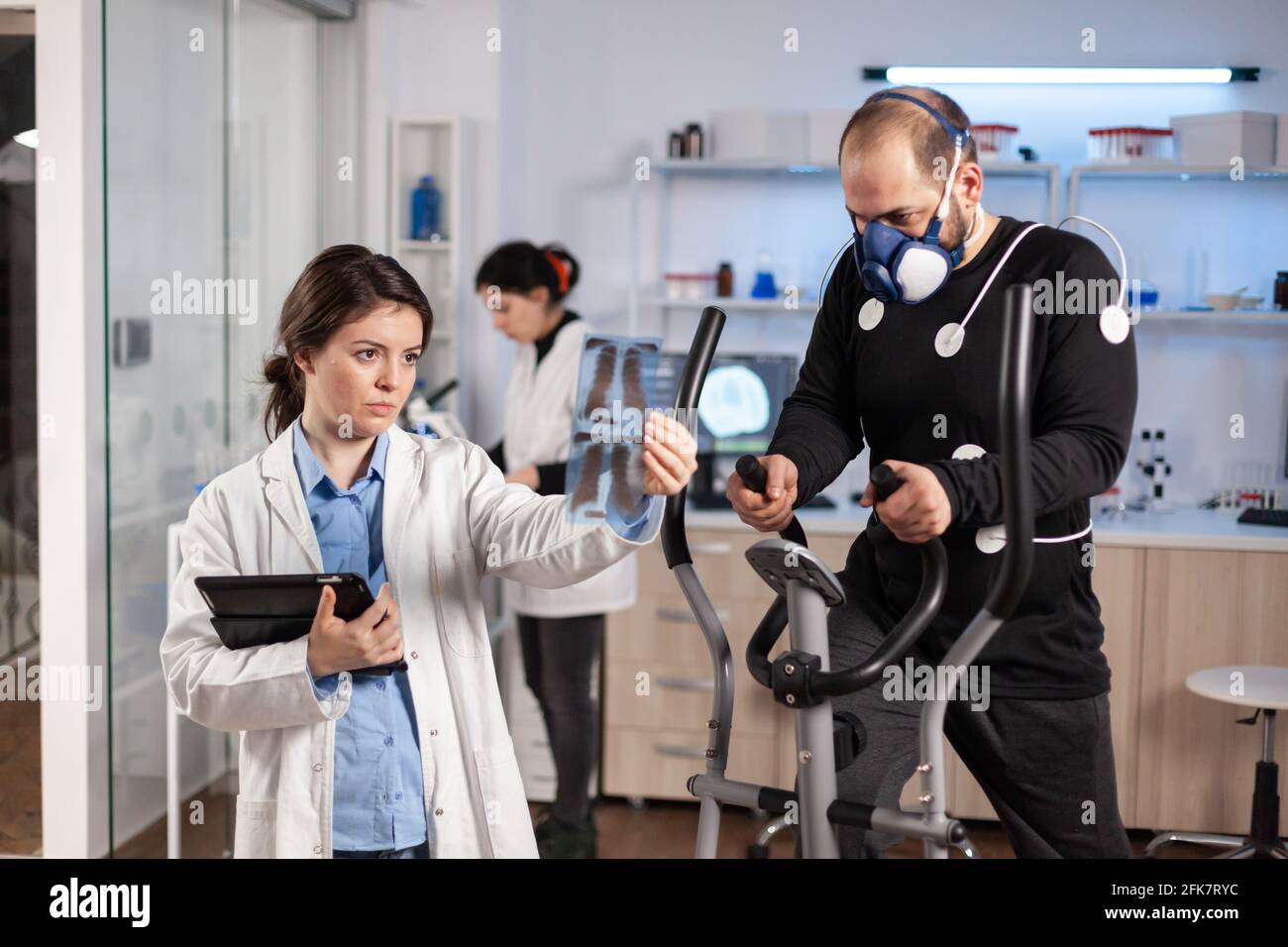 Medical doctors in sports science lab measuring performance ...