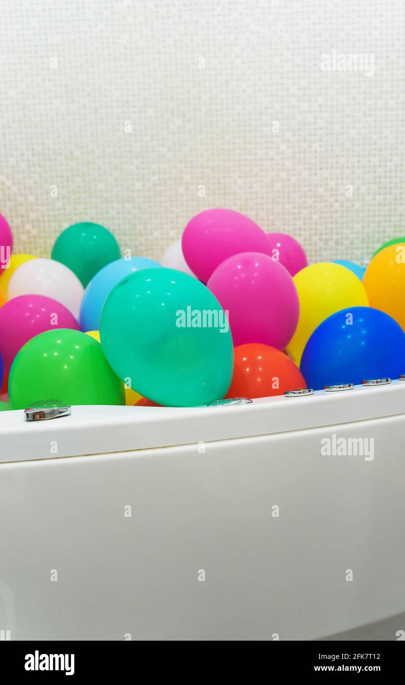 The bathtub is filled with colorful balloons Stock Photo - Alamy