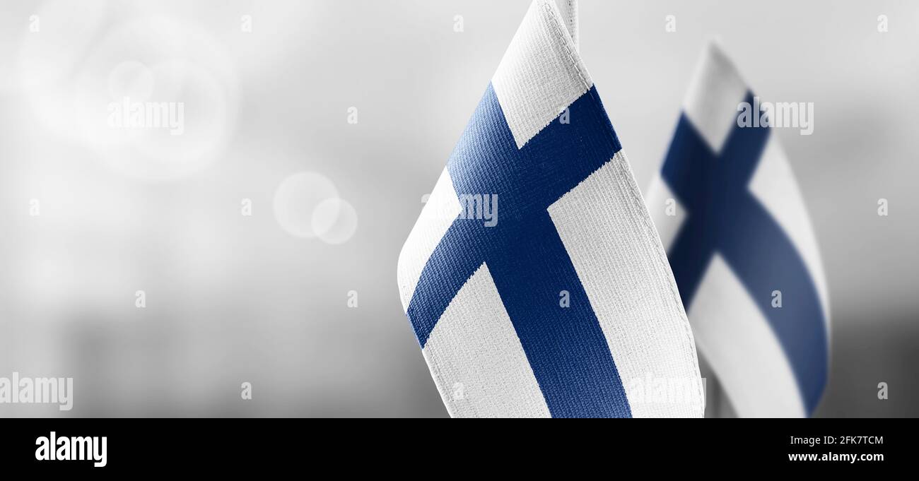 Small national flags of the Finland on a light blurry background Stock ...