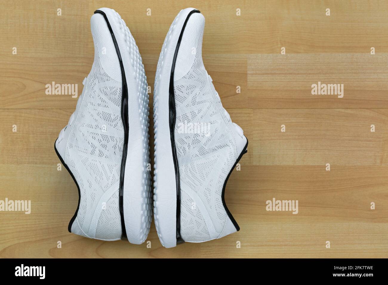 Top view side of white casual shoes with black lines on wooden ...