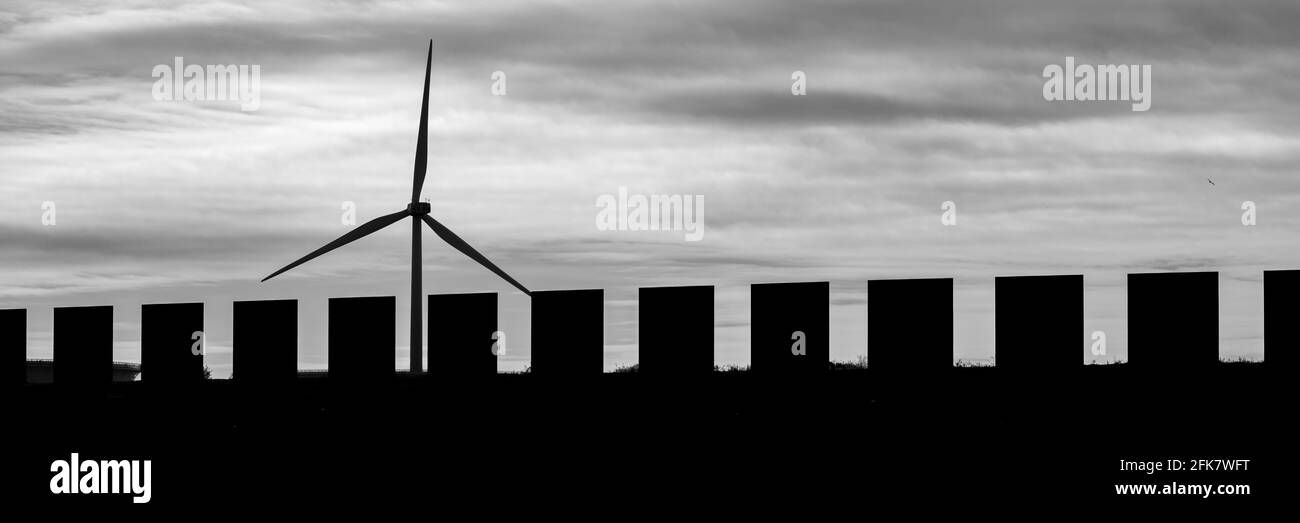 Concrete road barrier with a windmill on a clear sky background in ...