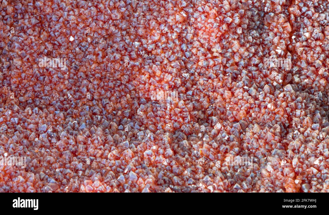 Texture of orange quartz crystals piled together, glinting in the ...