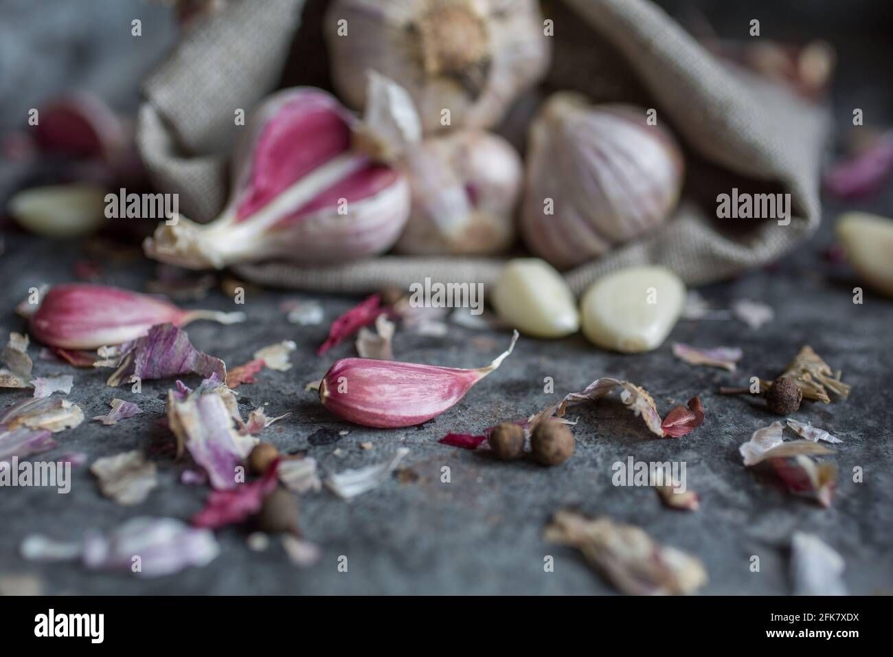 The process of cleaning garlic. Garlic and leaves on wooden background ...