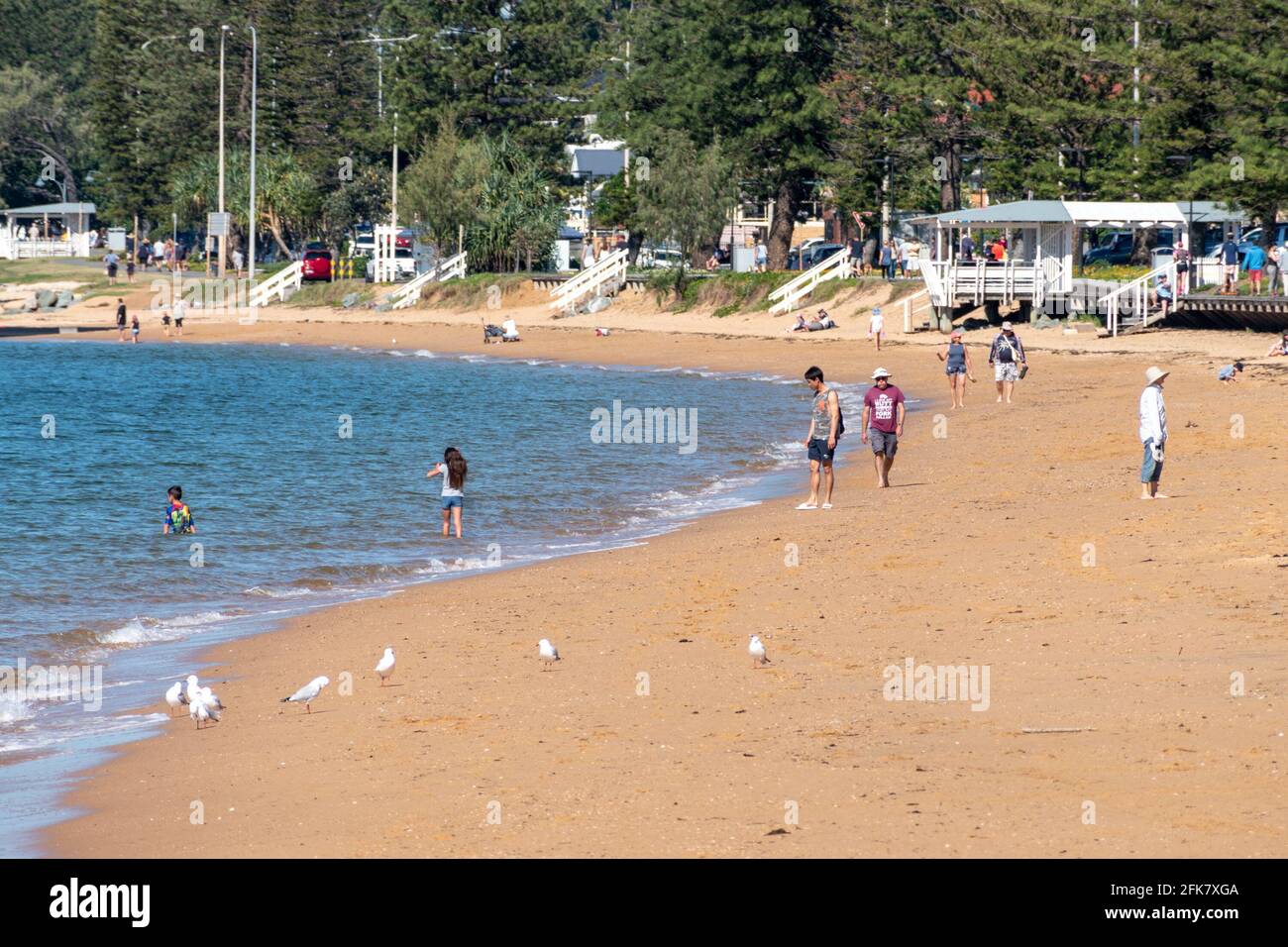 Families walking and paddling, enjoying sunny weather on Margate Beach ...