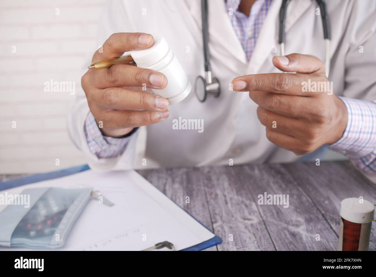 doctor hand holding pill container with copy space Stock Photo - Alamy