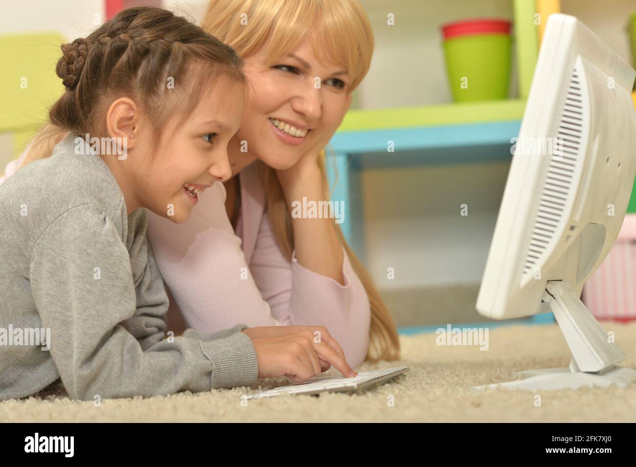 Portrait of mother and daughter using computer Stock Photo - Alamy