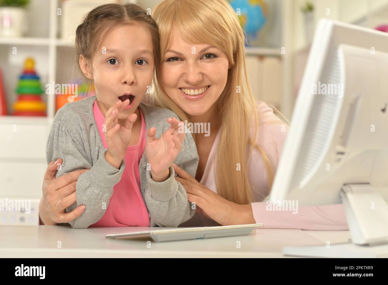 Portrait of mother and daughter using computer Stock Photo - Alamy