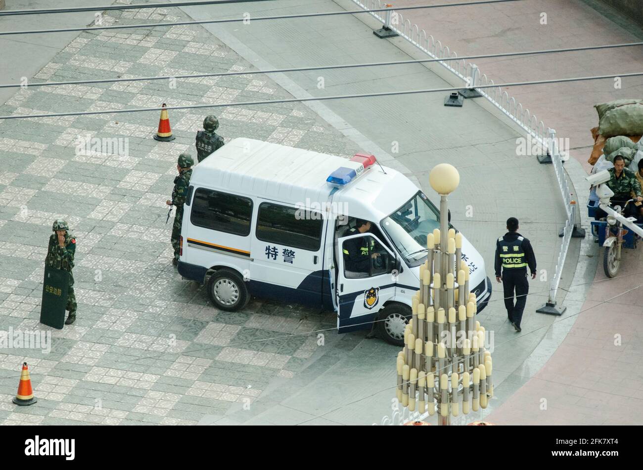 Security police with shields, batons and firearms stand by a police van ...