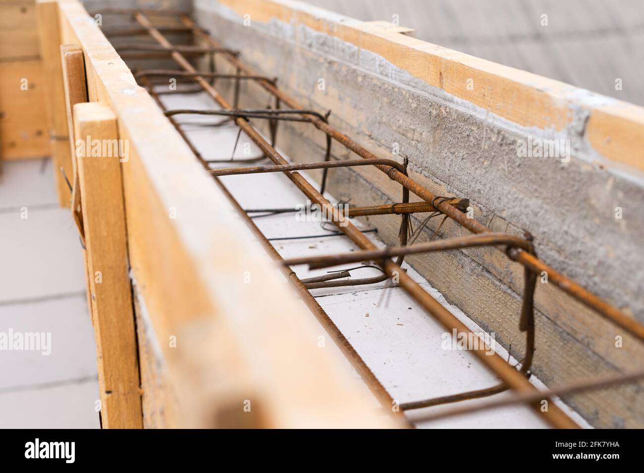 Reinforced belt in wooden formwork at a construction site close up ...