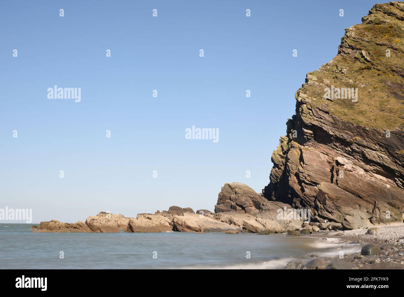 Cliff edge and rocks with waves from the ocean in landscape Stock Photo ...