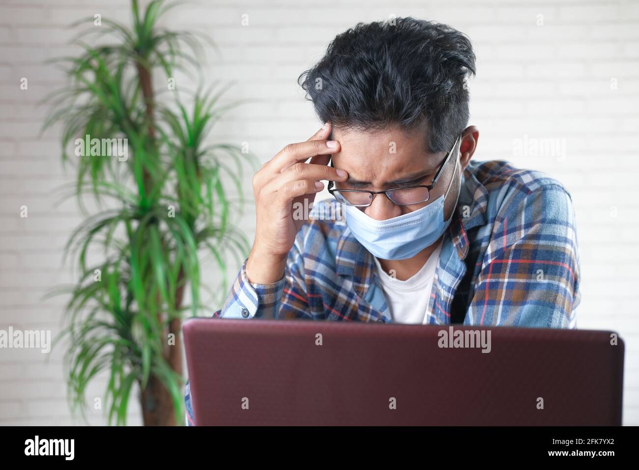 A young asian man with protective mask in face feeling sad Stock Photo ...