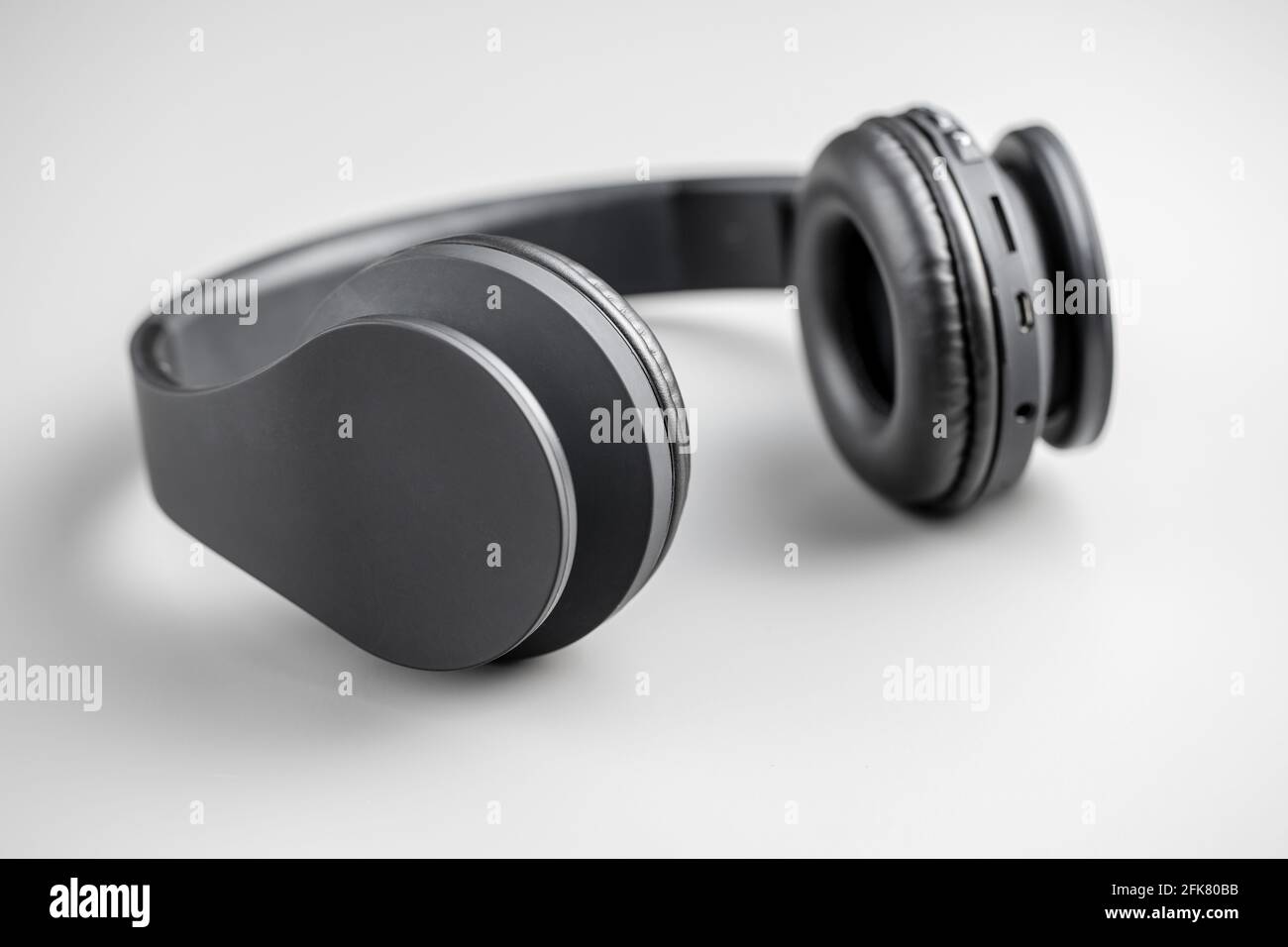 Gray wireless headphones on a gray background Stock Photo - Alamy