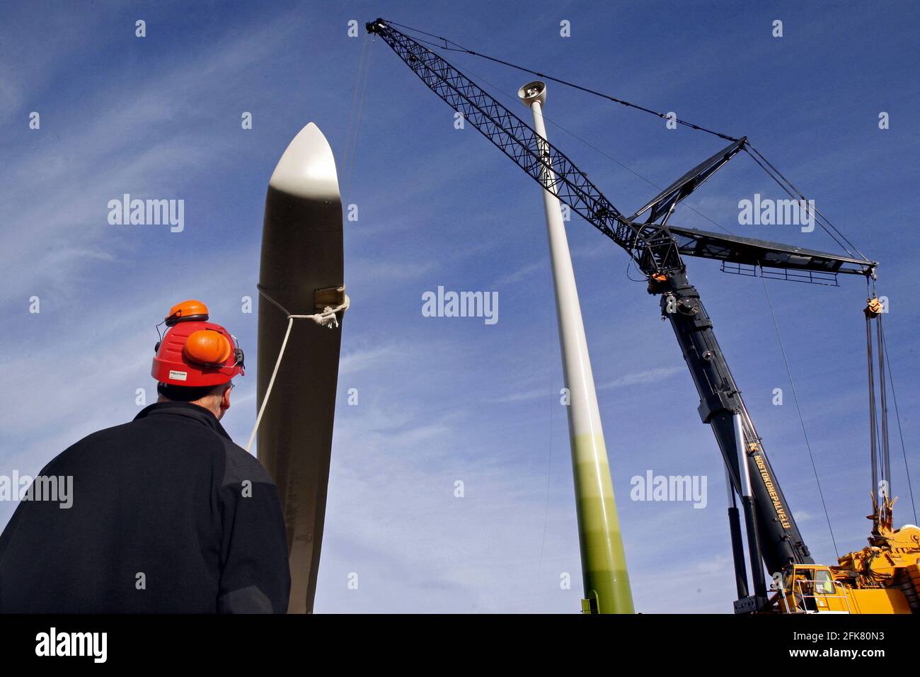 A worker during the construction of a wind turbine Stock Photo - Alamy