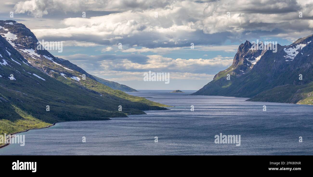 Snowy mountains rise from cold waters of norwegian fjord Stock Photo ...