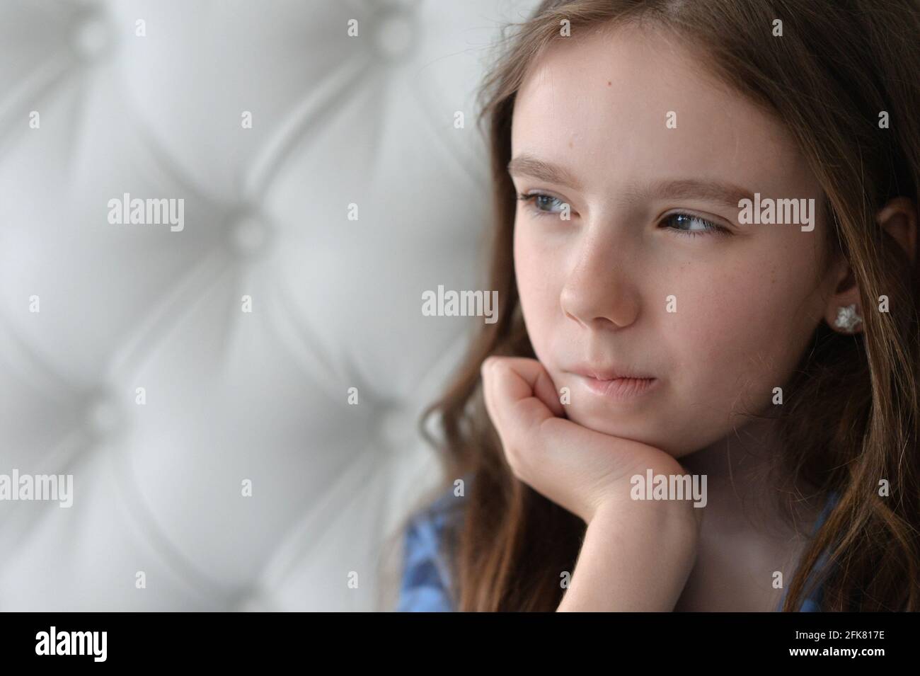 Portrait of cute sad girl posing at home Stock Photo - Alamy