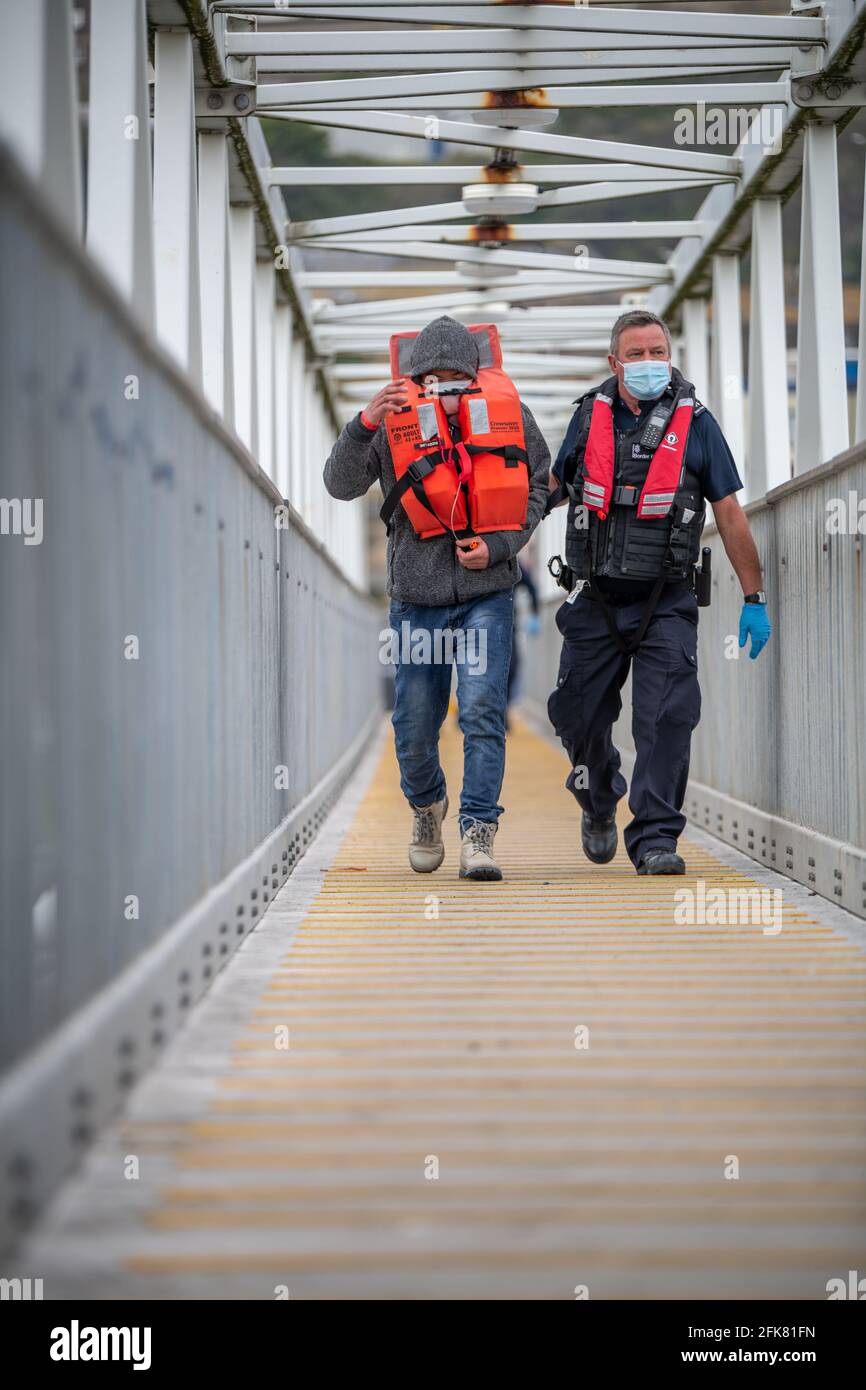 Migrants picked up off the coast of Dover are brought to the harbour ...