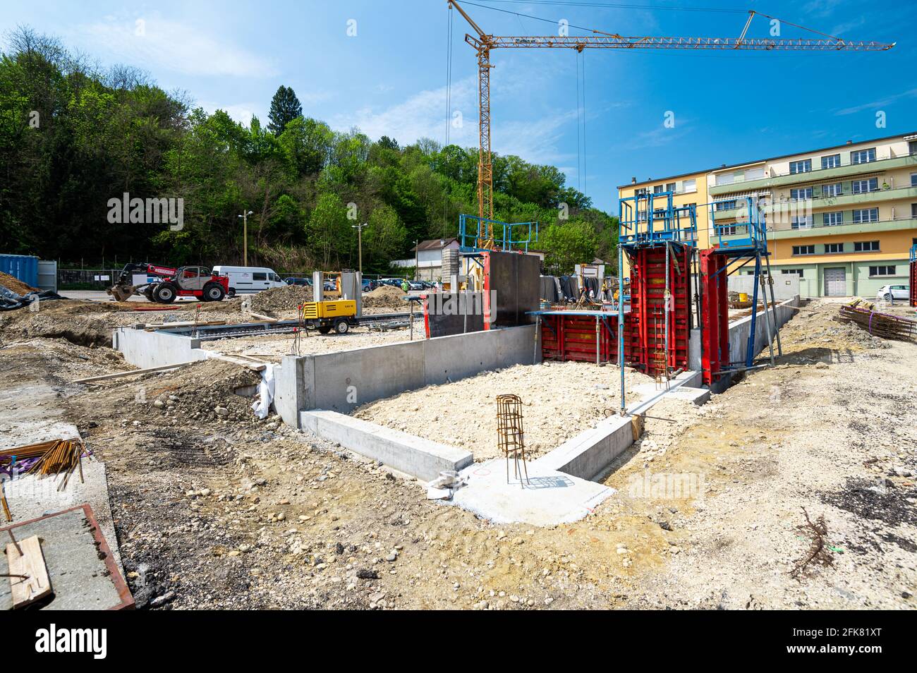 Ground level shot of a crane under a blue sky at a construction site ...