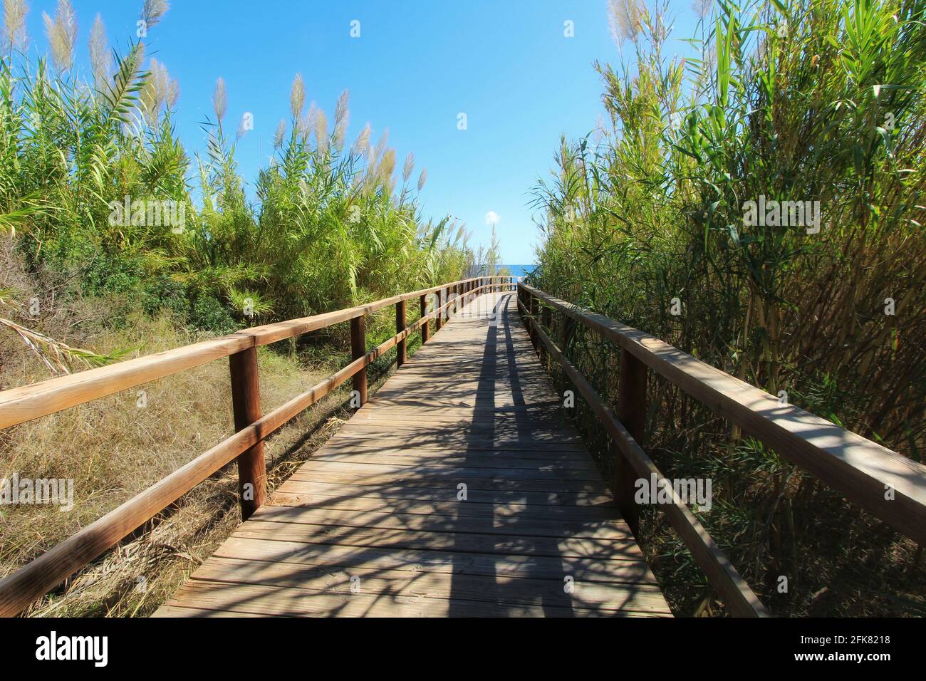 Wooden walkway to Arenales del Sol beach in a beautiful morning in ...