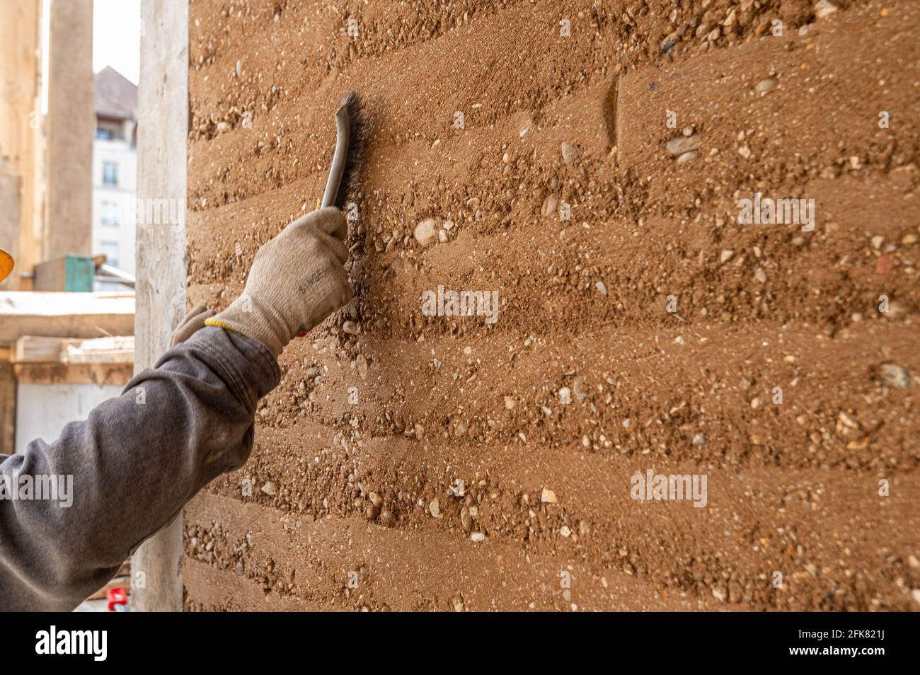 Picture of a Construction worker's hand completing a process in rammed ...