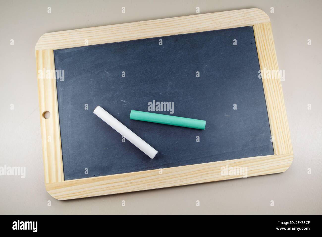 Chalkboard slate with white and green chalks for school Stock Photo - Alamy