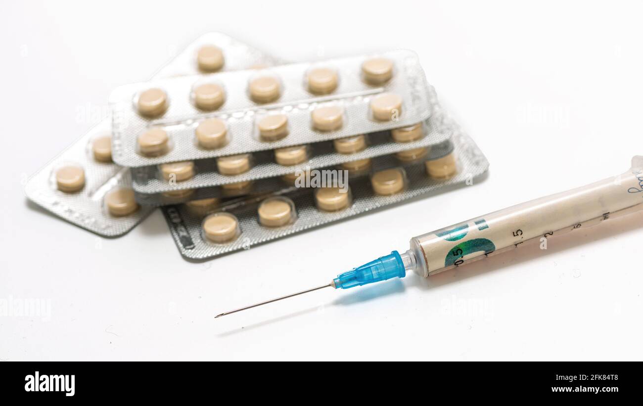 tablets and medical syringe isolated on white background Stock Photo ...