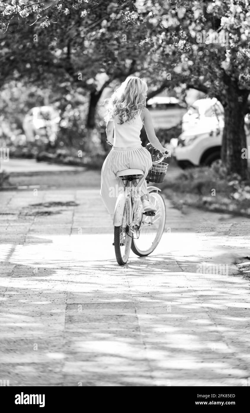 Spring holiday. woman ride vintage bicycle. romantic girl under sakura ...