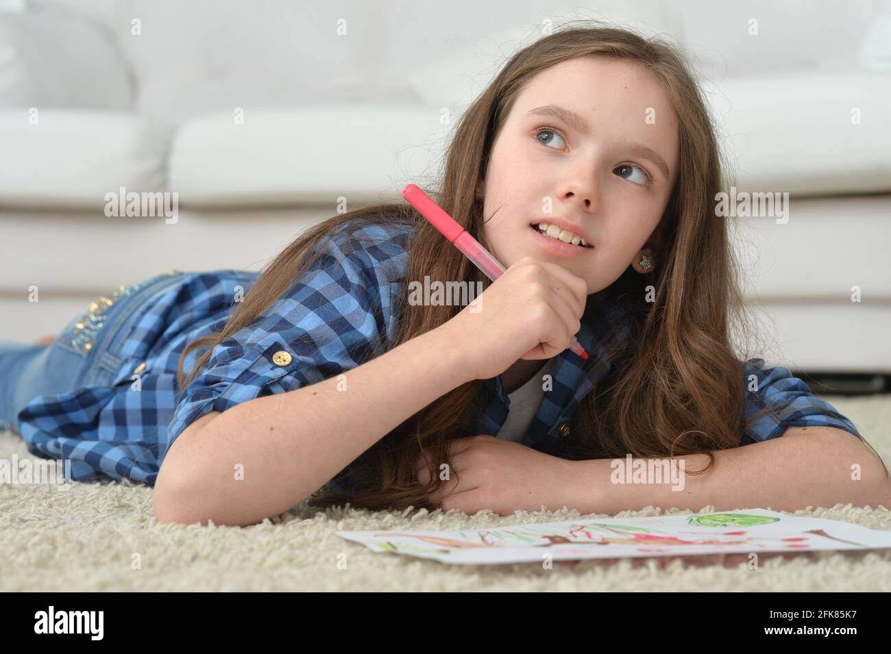 Portrait of cute smiling girl drawing at home Stock Photo - Alamy