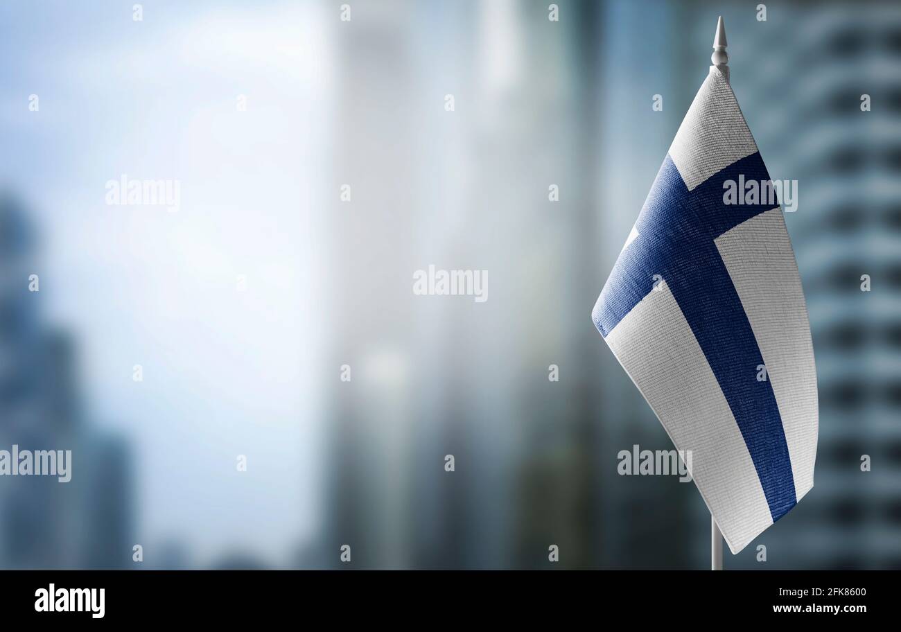 A small flag of Finland on the background of a blurred background Stock ...