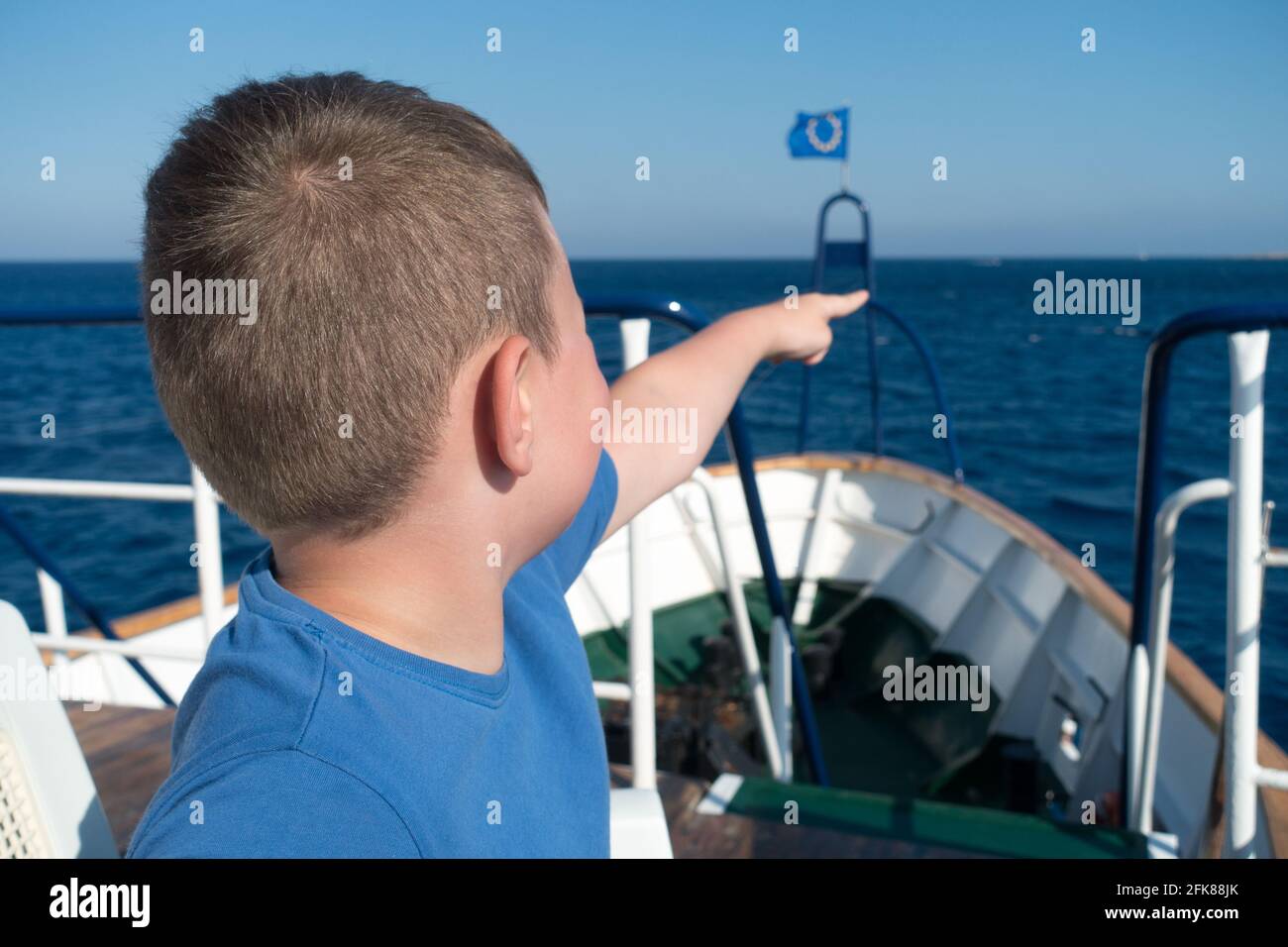 boy on a ship sets sail in the blue sea Stock Photo - Alamy
