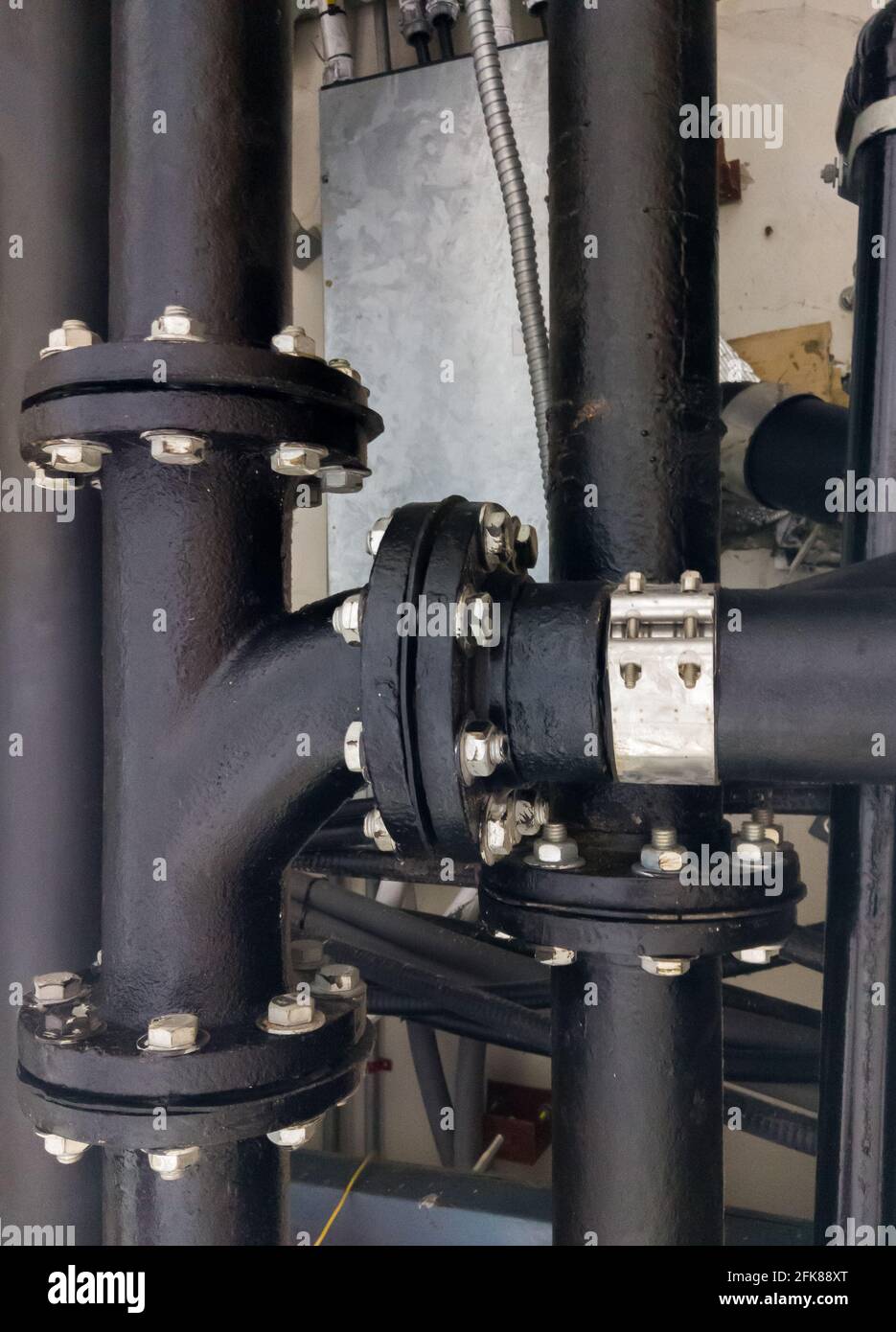 The large black steel pipe with the tree way socket in the joint point ...