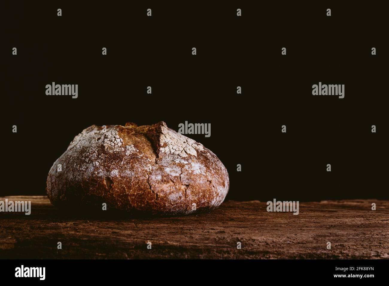 isolated rustic and golden round loaf of fresh whole grain bread on ...