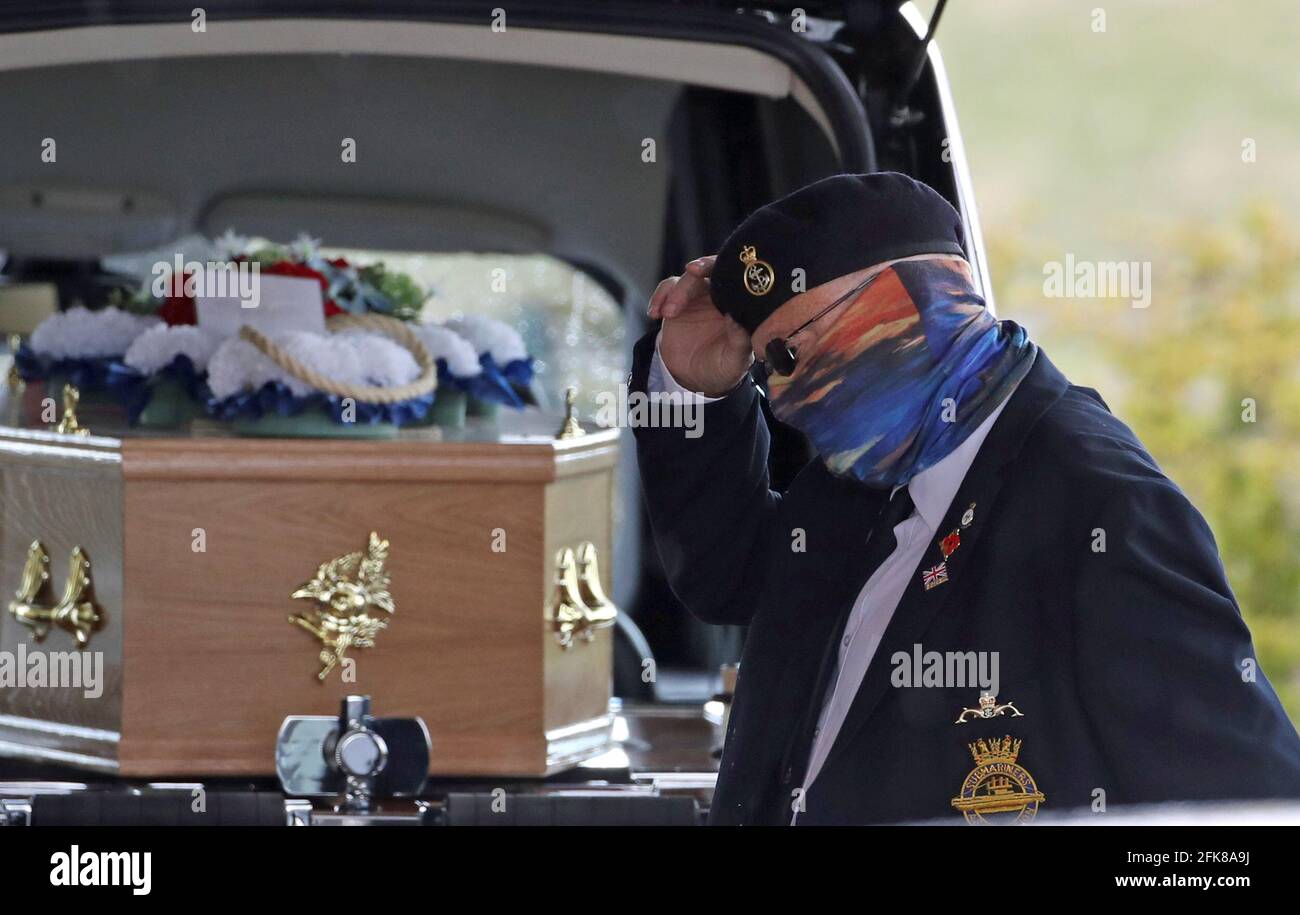 A retired submariner tips his hat as he passes the coffin at Stirling ...