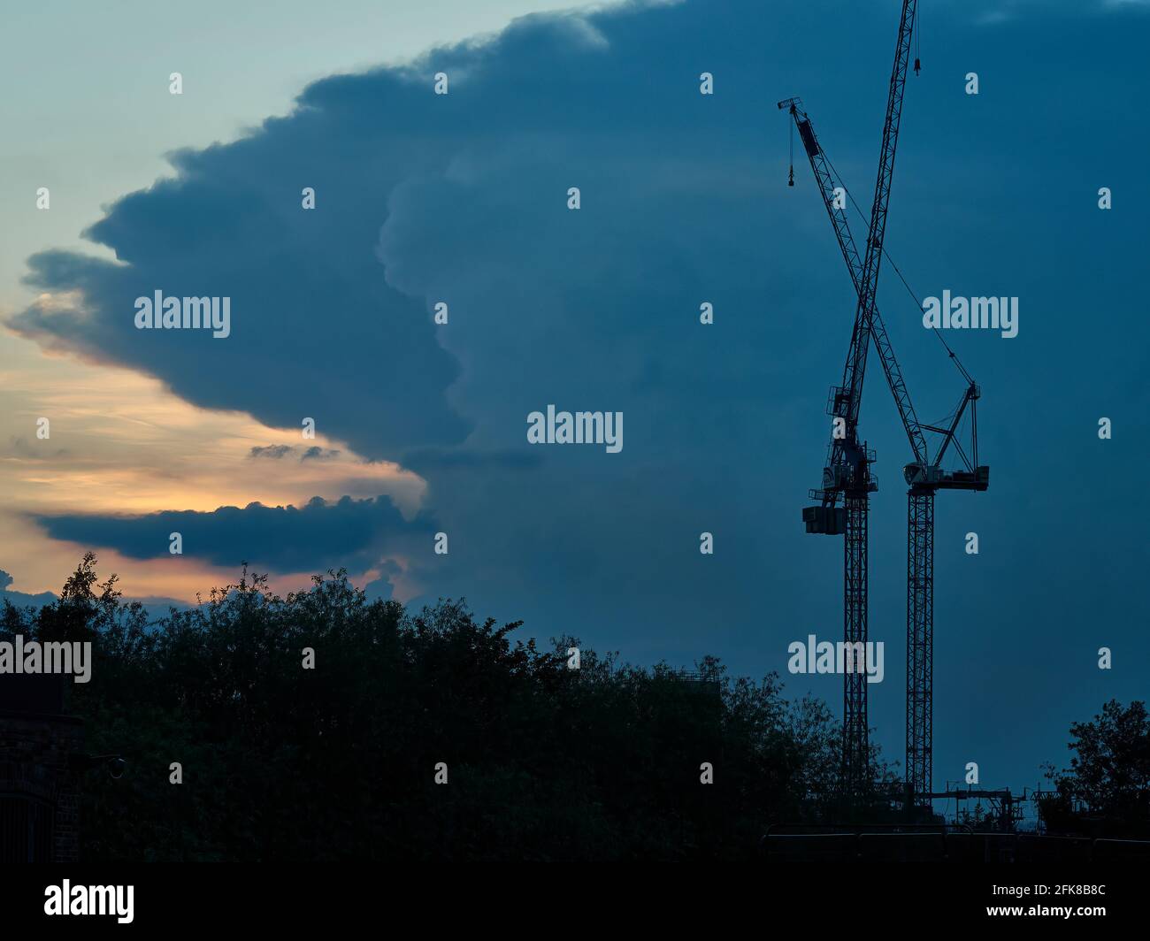 Crane against storm clouds hi-res stock photography and images - Alamy
