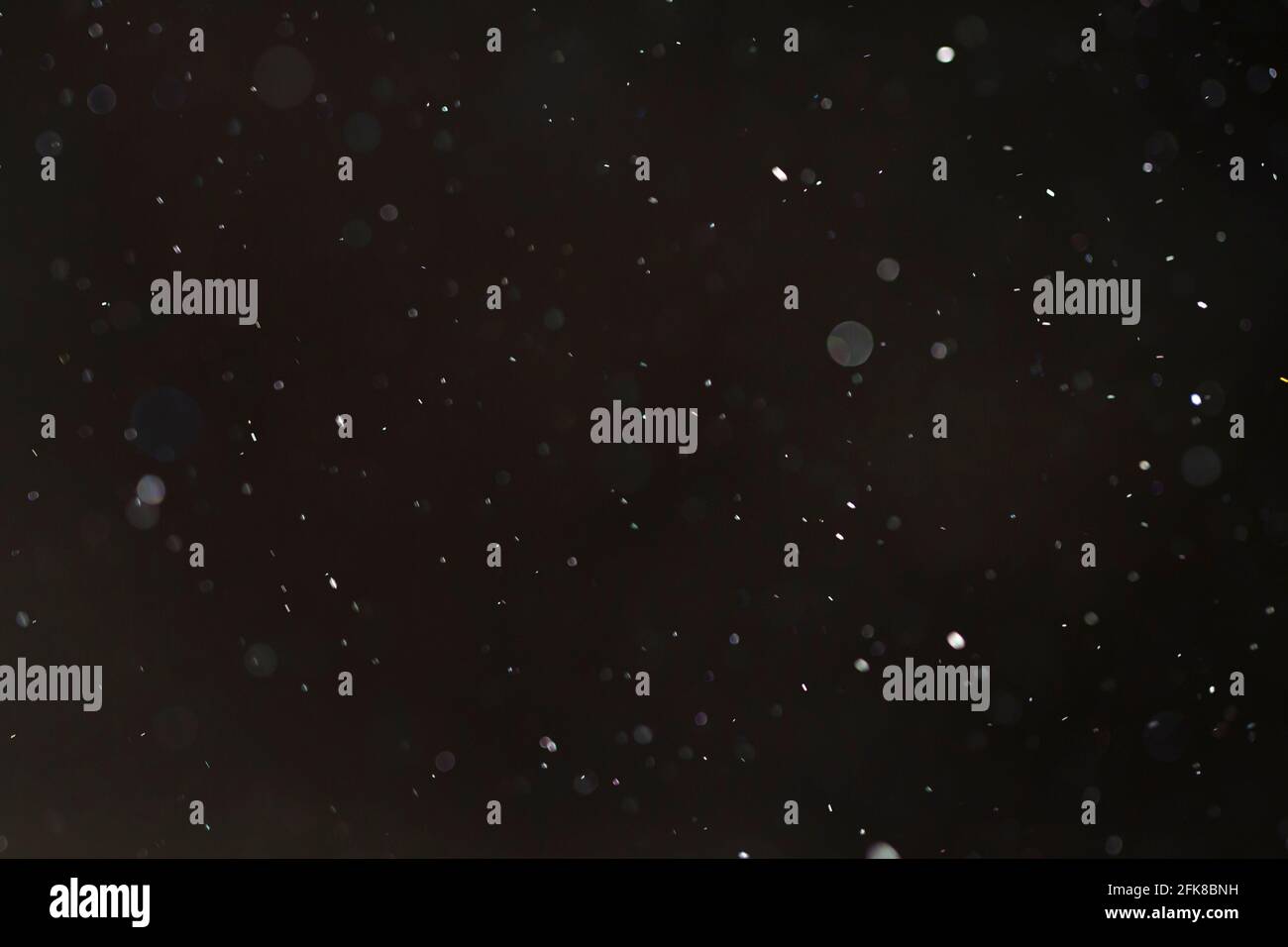 Dust particles and lens flare on a black background Stock Photo - Alamy