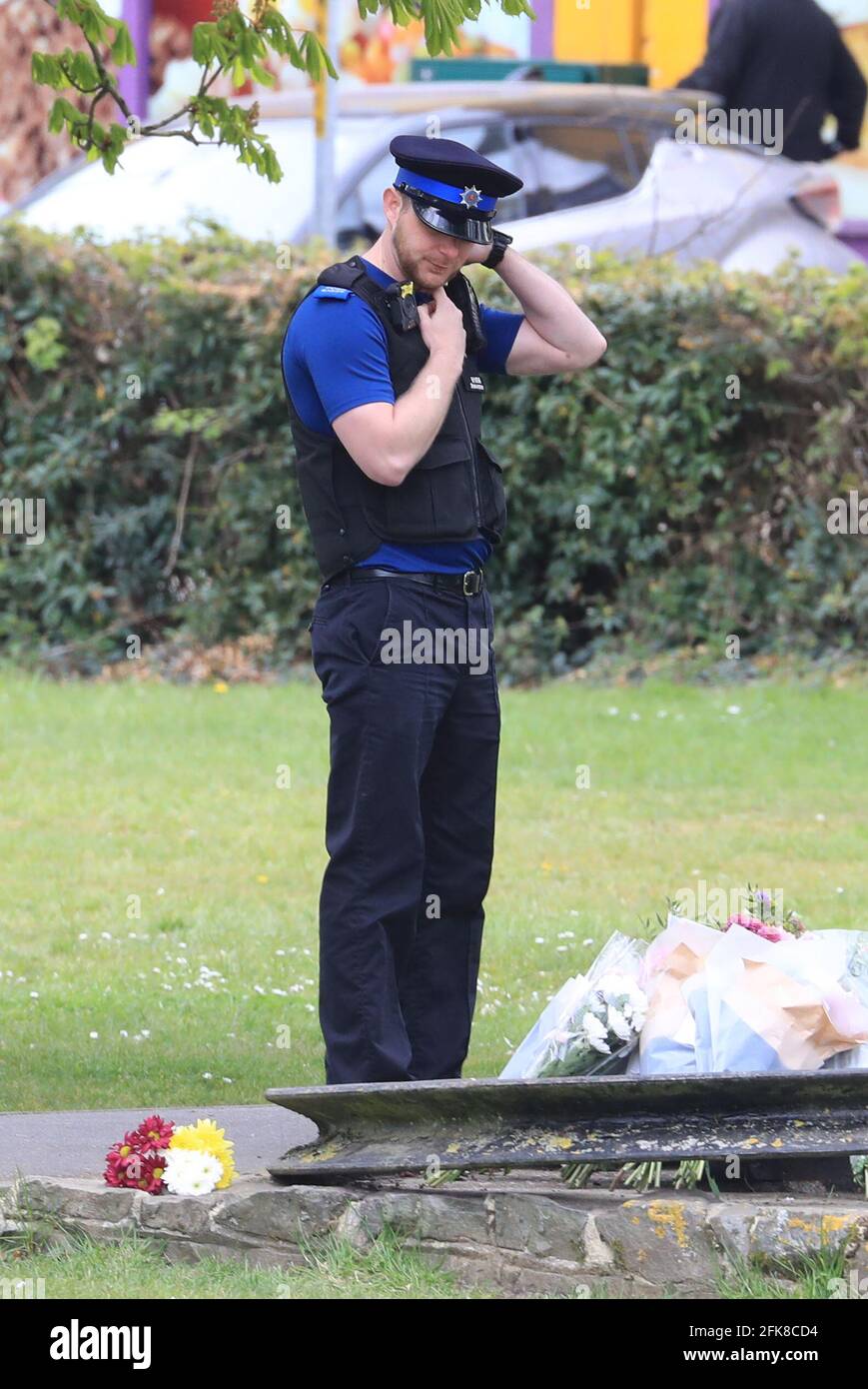 A PCSO looks at flowers and messages left in Aylesham, East Kent for ...