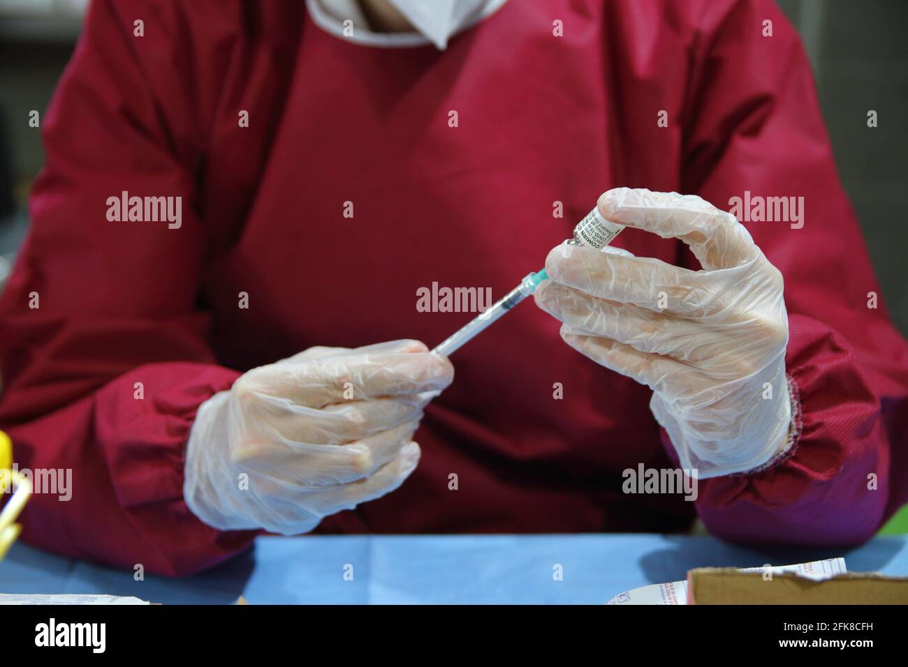 Nurse inside the pharmacy while preparing a syringe for the ...