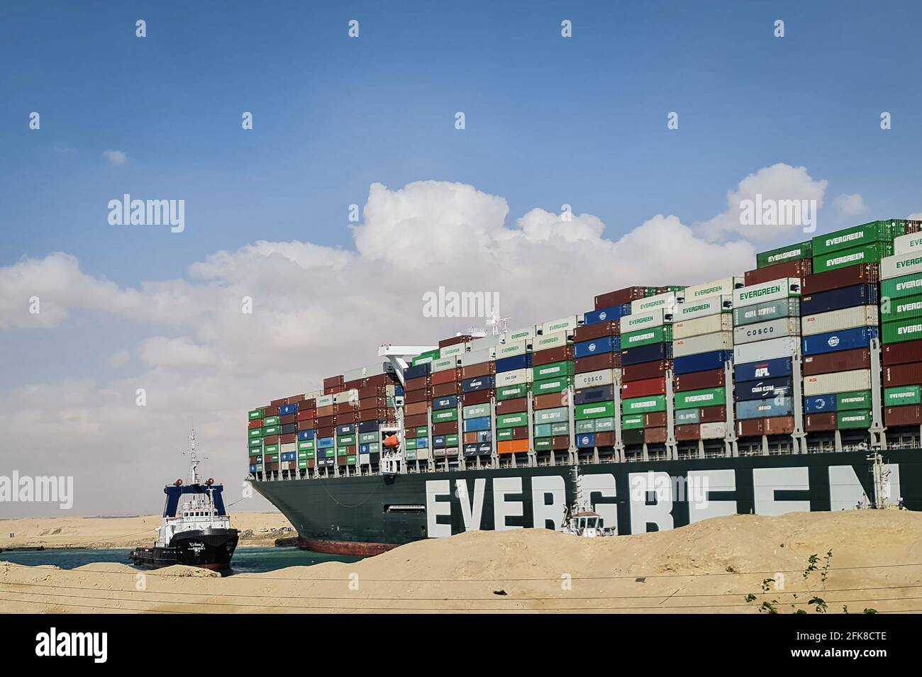 A tugboat takes part in the refloating operation carried out to free ...
