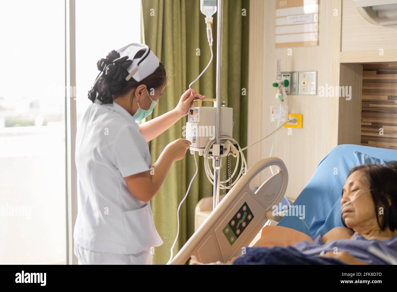 Patient in hospital bed adjusting hi-res stock photography and images ...