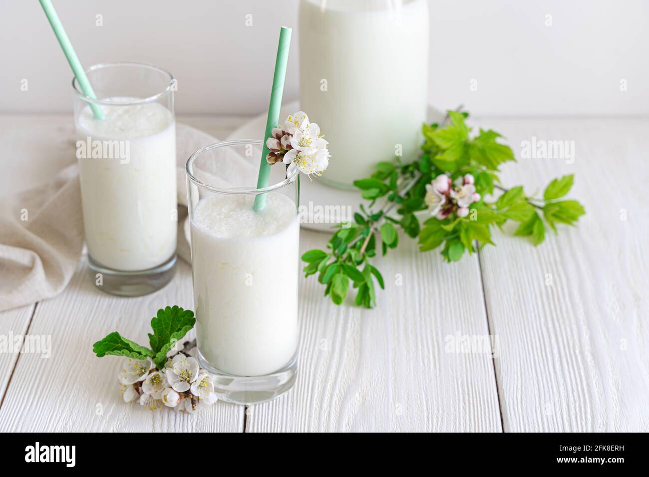 Fresh, natural yogurt drink on a white background. Two glasses of lassi ...
