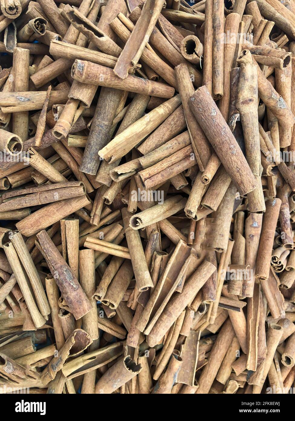 pile of dried cinnamon sticks as a background Stock Photo - Alamy