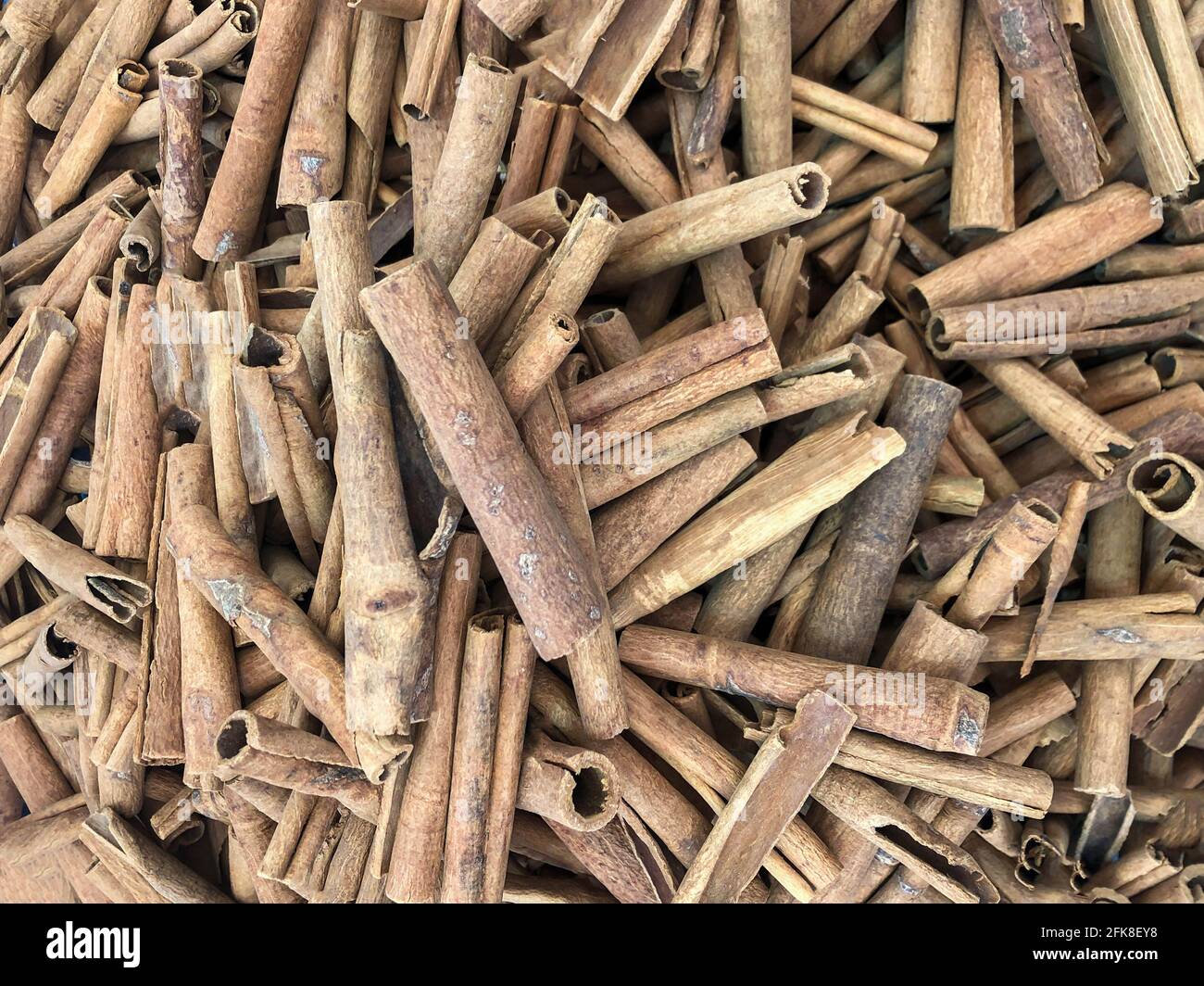 pile of dried cinnamon sticks as a background Stock Photo - Alamy